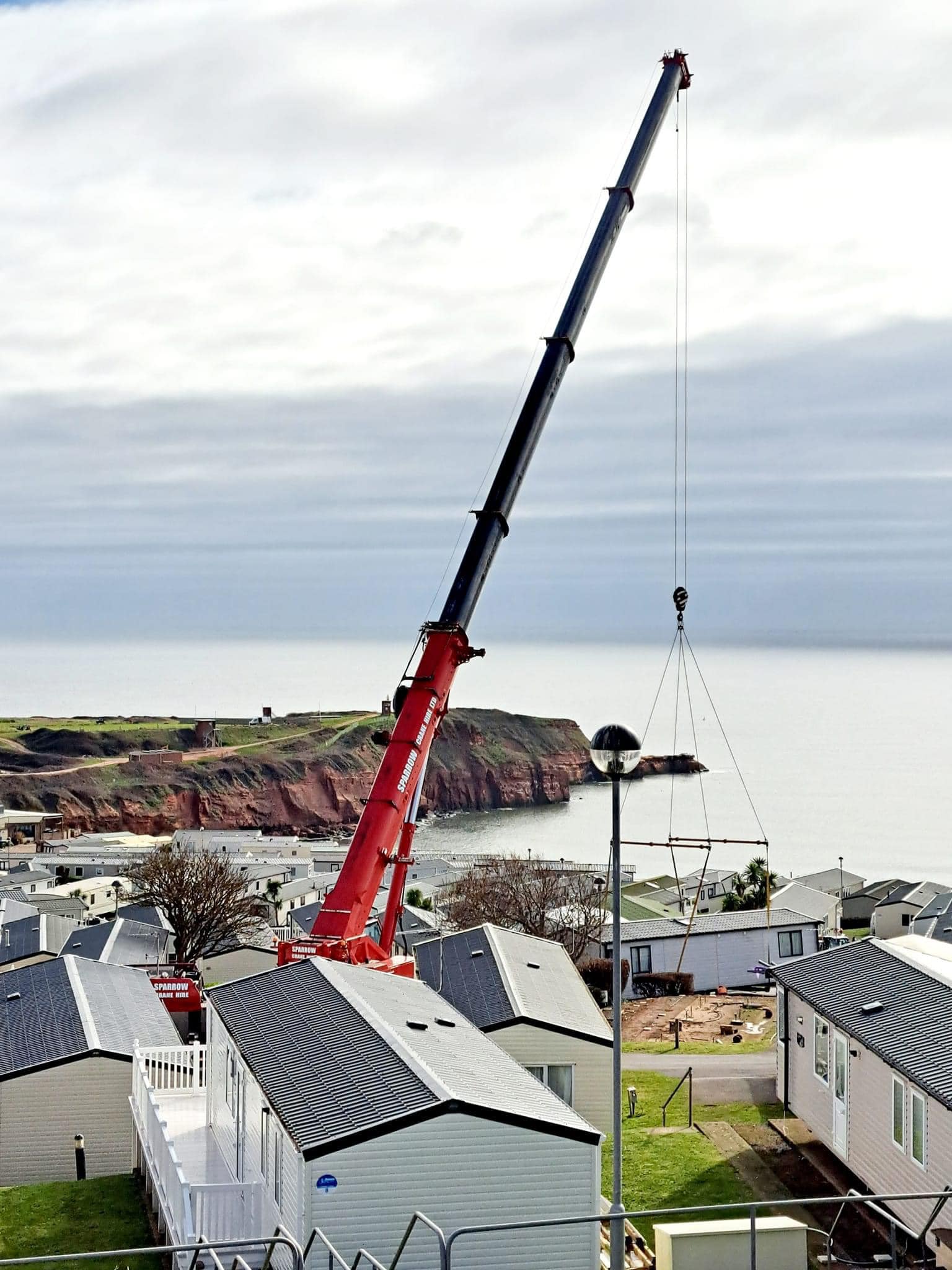 Grove GMK5250L relocating lodges at Devon Cliffs, Exmouth | Sparrow ...