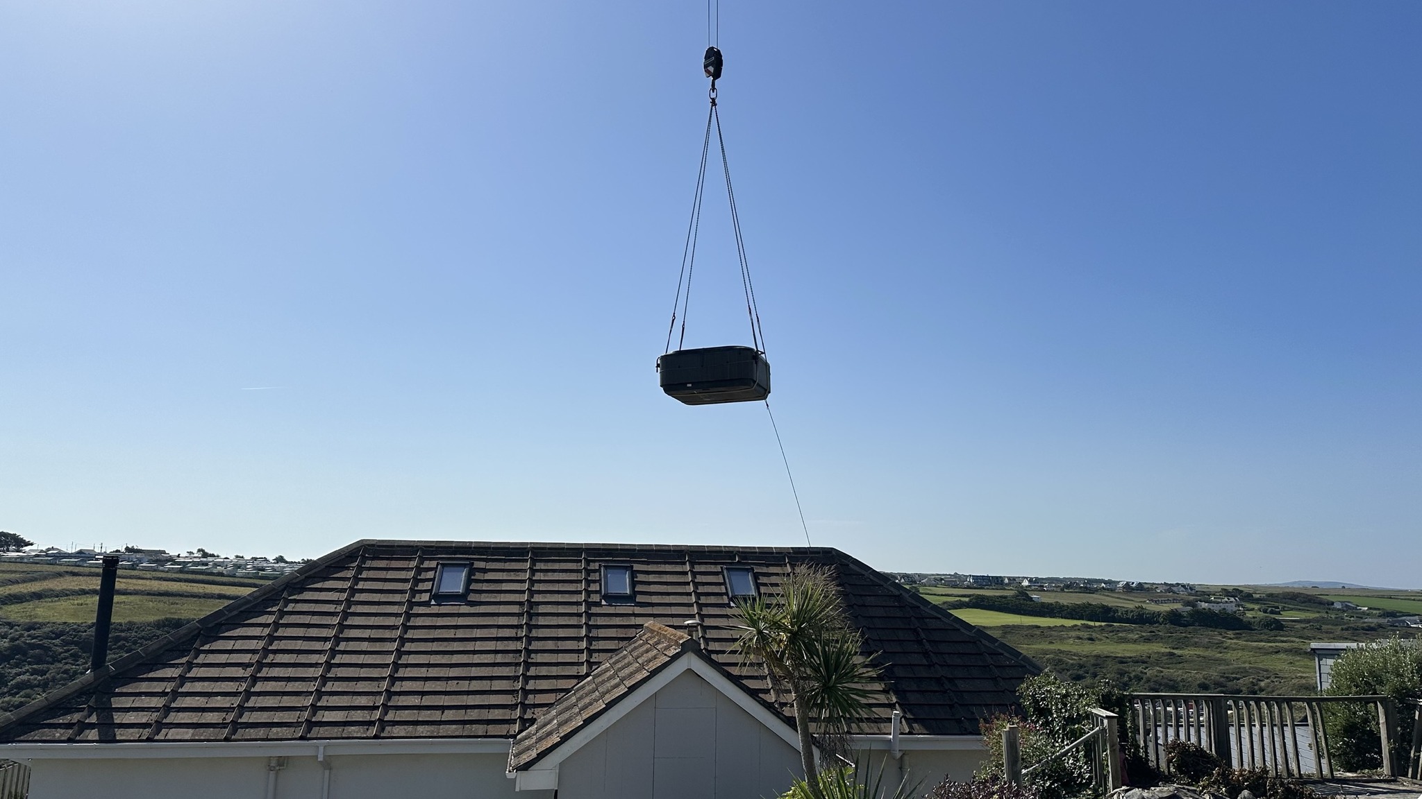Crane lifting with picturesque views over the River Gannel in Newquay ...